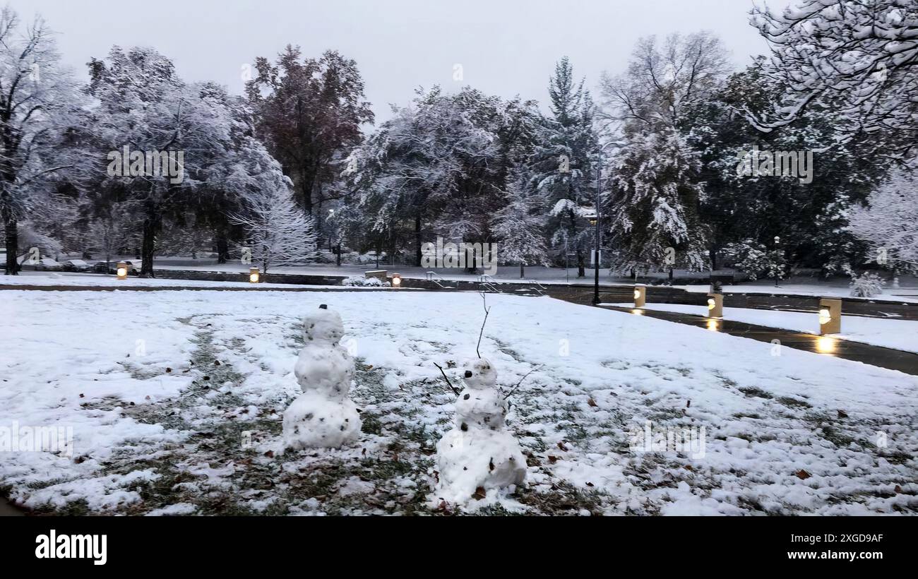 A serene winter landscape featuring snowmen in a Manhattan KS park with ...