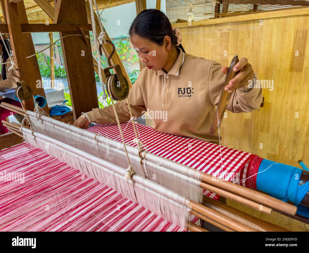 Woman working on various craft projects at the Satcha Handicraft Center ...