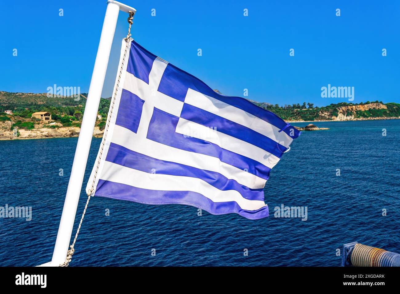 Blue and white Greek flag with cross waving against blue sky, Zakynthos ...