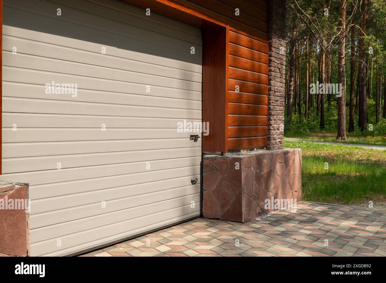 Modern garage door with horizontal panels and keypad beside a dark ...