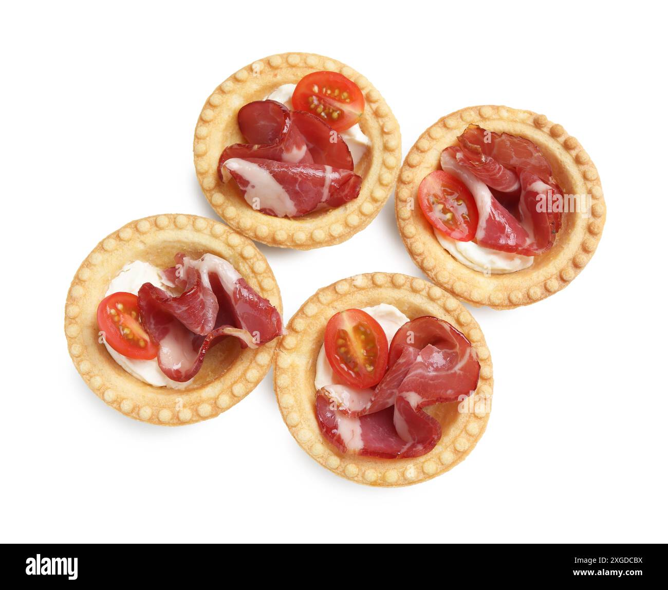 Delicious canapes with jamon, cream cheese and cherry tomatoes isolated ...
