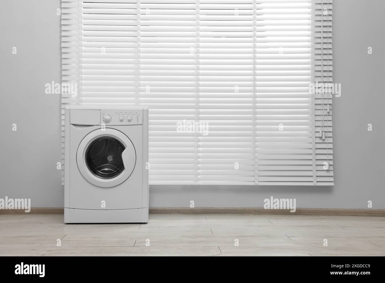 One washing machine near window in laundry room Stock Photo - Alamy