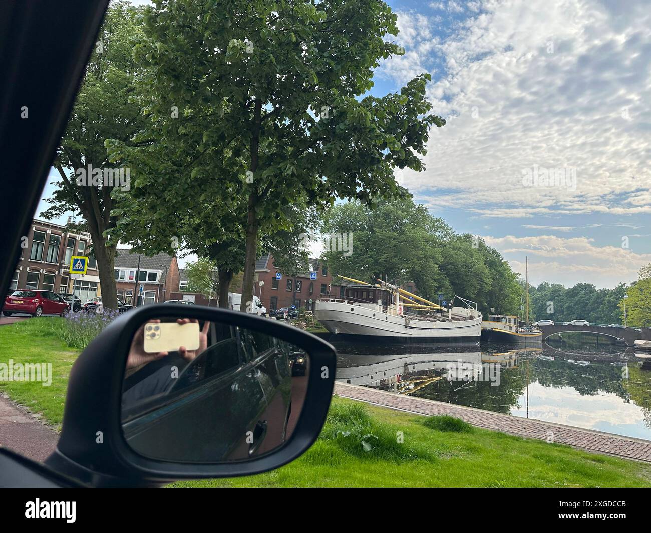 Canal with boats in city, view from driver's seat Stock Photo - Alamy