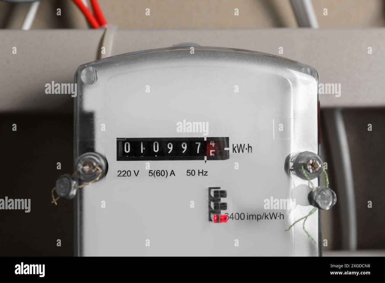 Electric meter and wires in fuse box, closeup. Energy measuring device ...