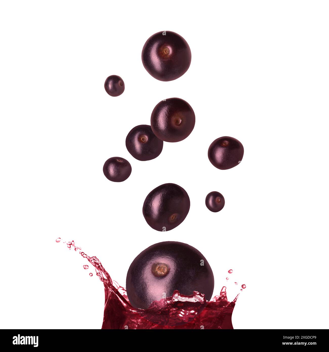 Acai berries falling into juice on white background Stock Photo - Alamy