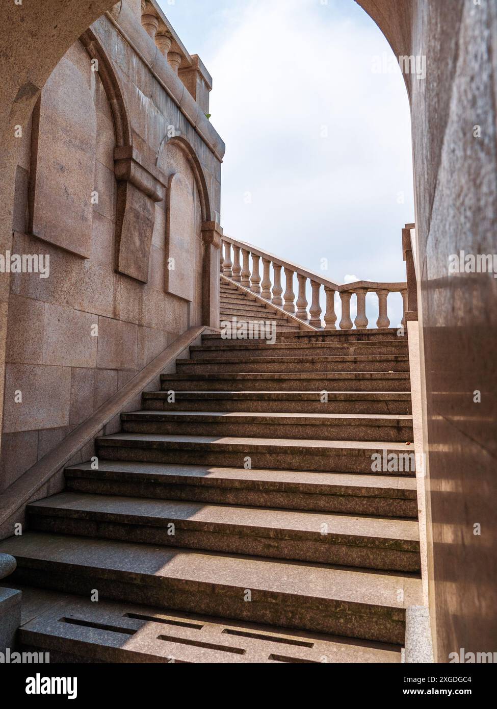 Stone staircase with ornate railings leading to balcony, set against ...