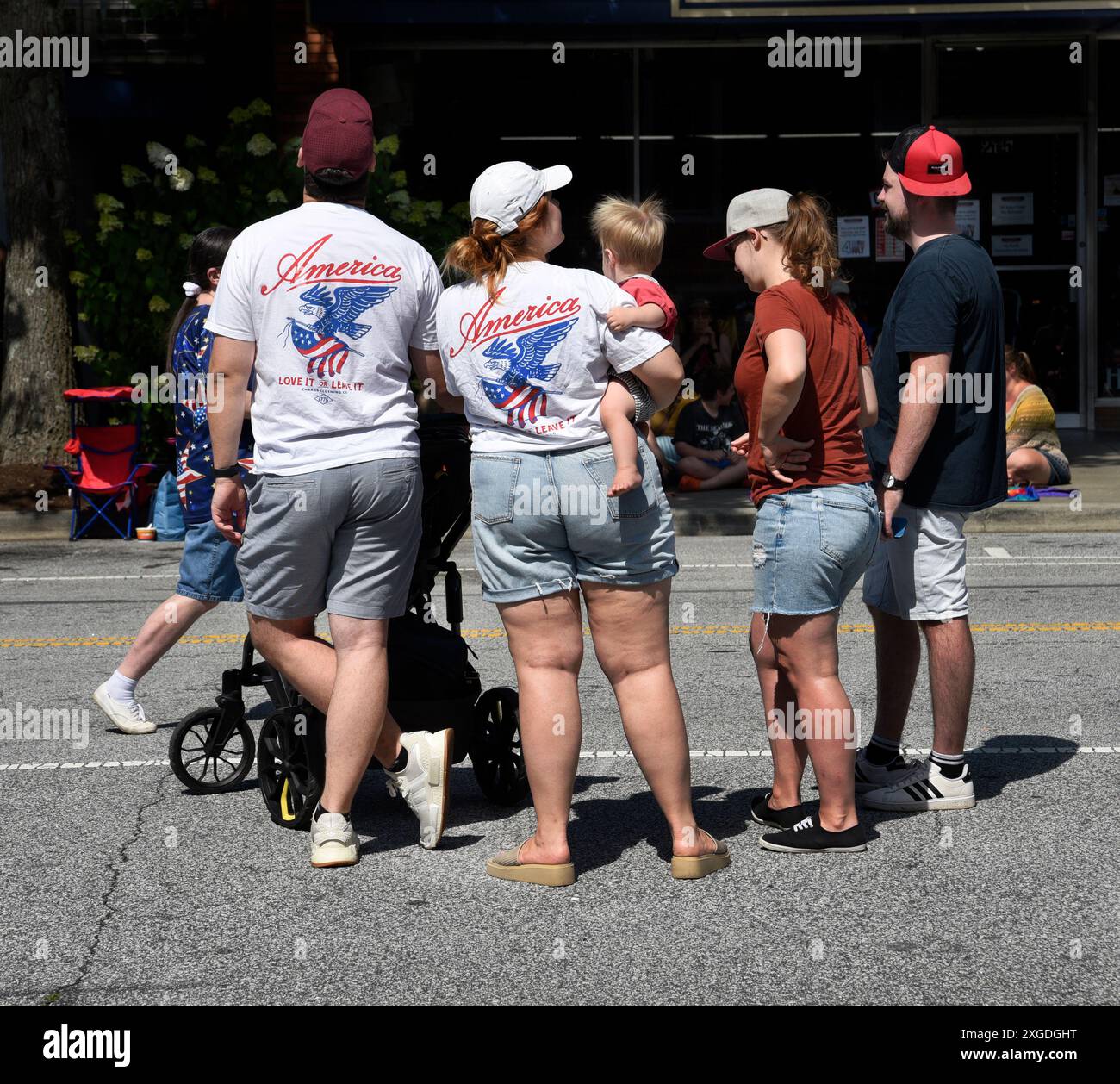 A couple wearing matching "American Love It or Leave It" T-shirts watch ...