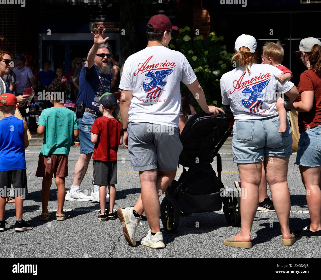 A couple wearing matching "American Love It or Leave It" T-shirts watch ...