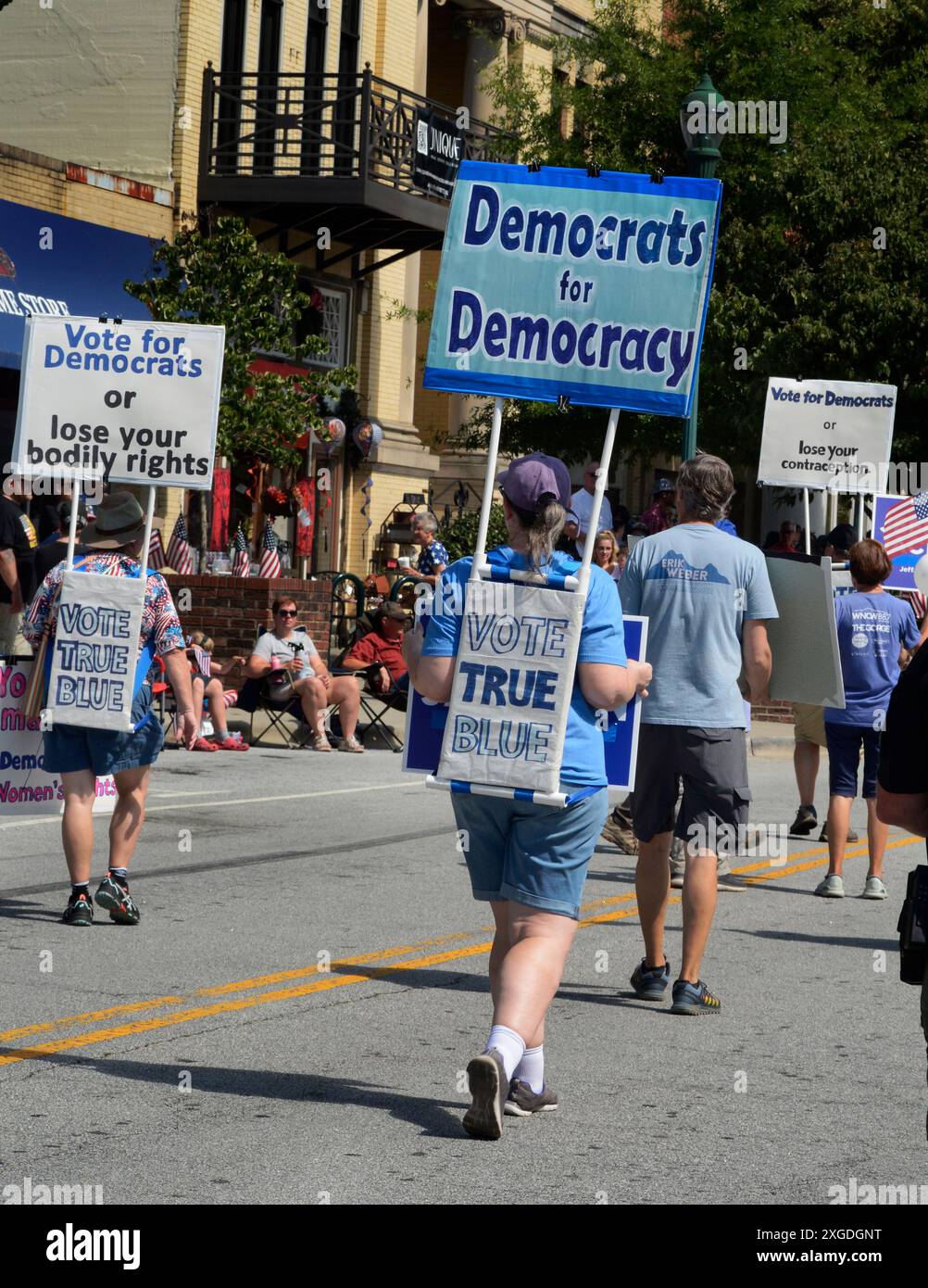 American Democratic Party supporters with signs march in a 2024 Fourth ...