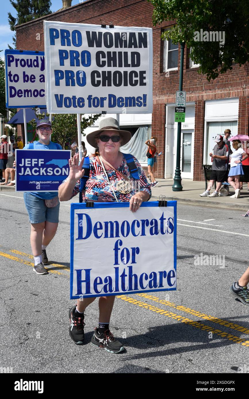 American Democratic Party supporters with signs march in a 2024 Fourth ...