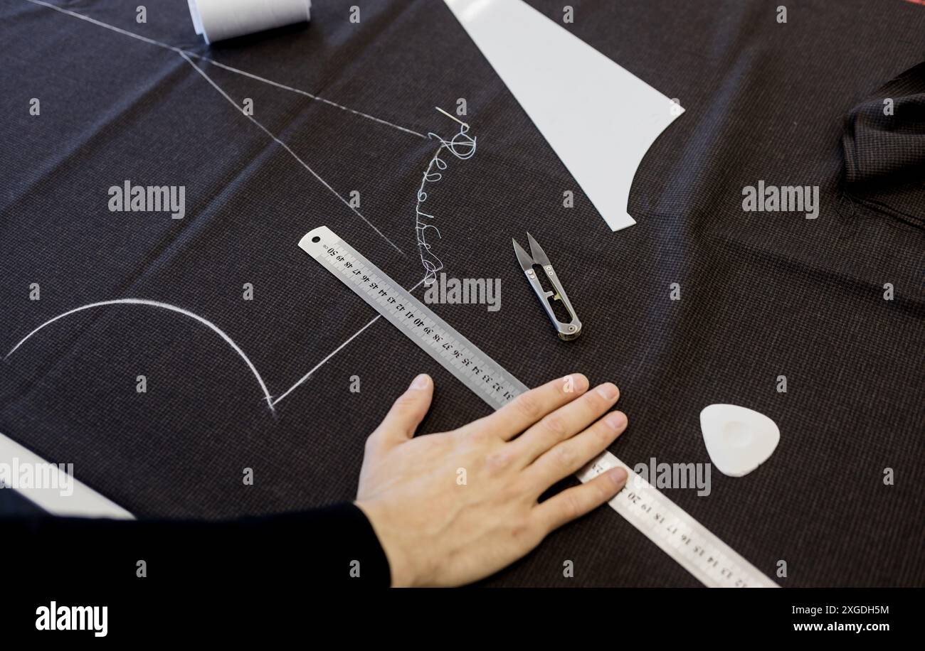 male tailor works in atelier. Fashion and hand craft concept Stock ...