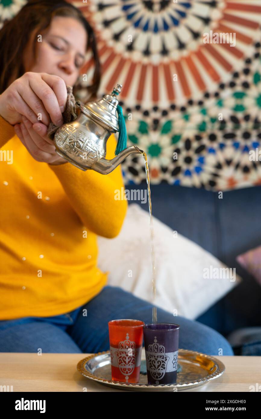Tourist woman pouring mint tea in a tea shop in Morocco Stock Photo - Alamy