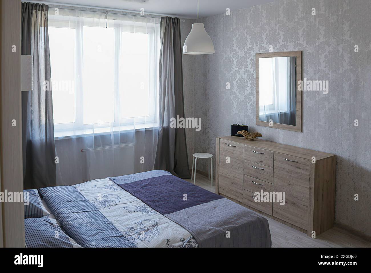 Interior of a beautiful bedroom. A bedroom in a new apartment with a double bed with a blue ...