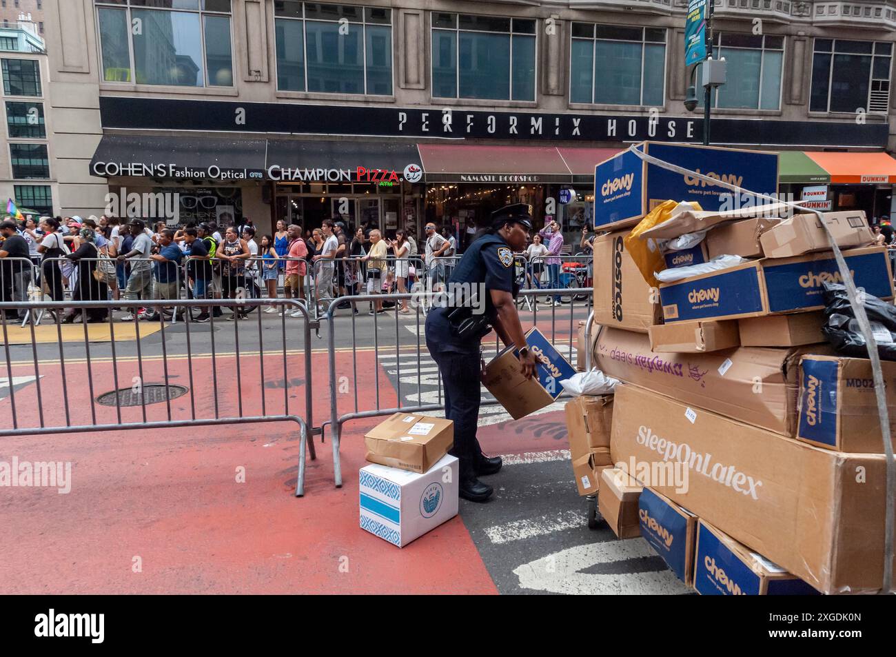 NYPD officer assists a delivery worker after the collapse of his ...