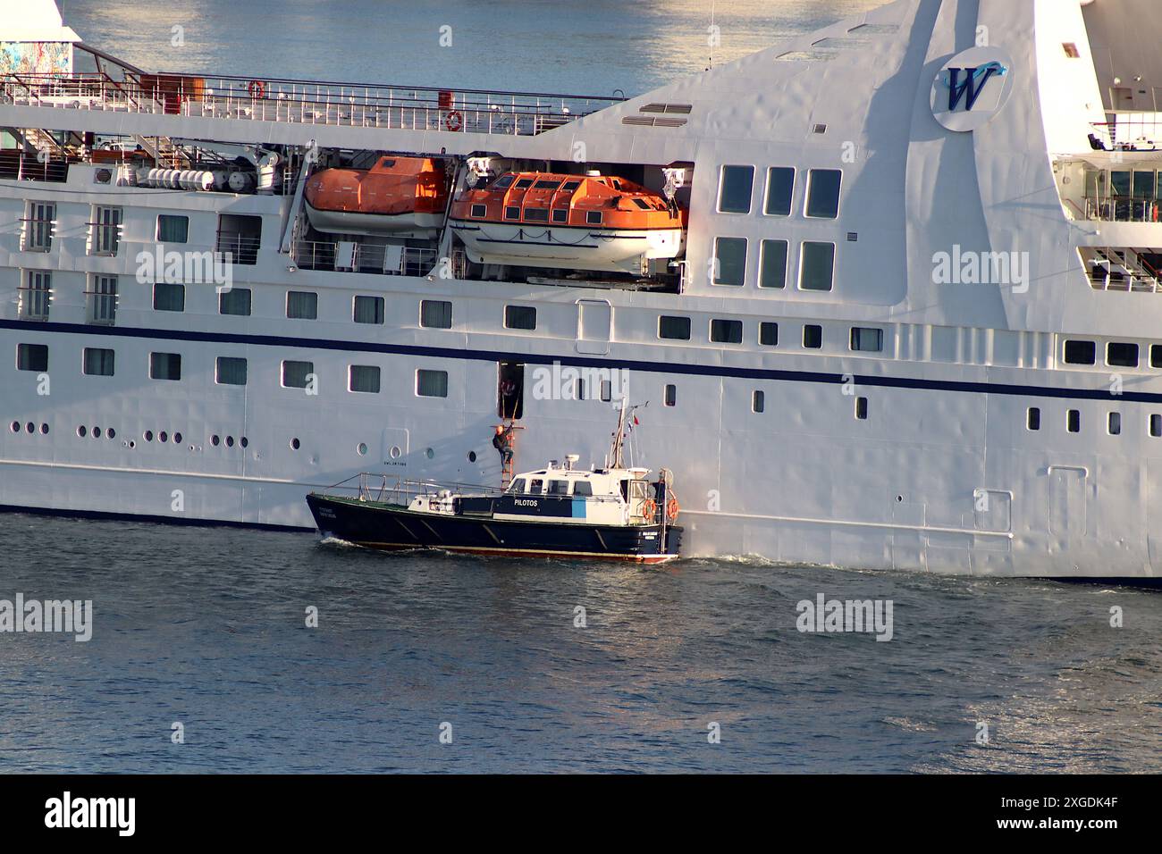 Portugeuse pilot boat runs parallel to the cruise ship Star Pride, as ...