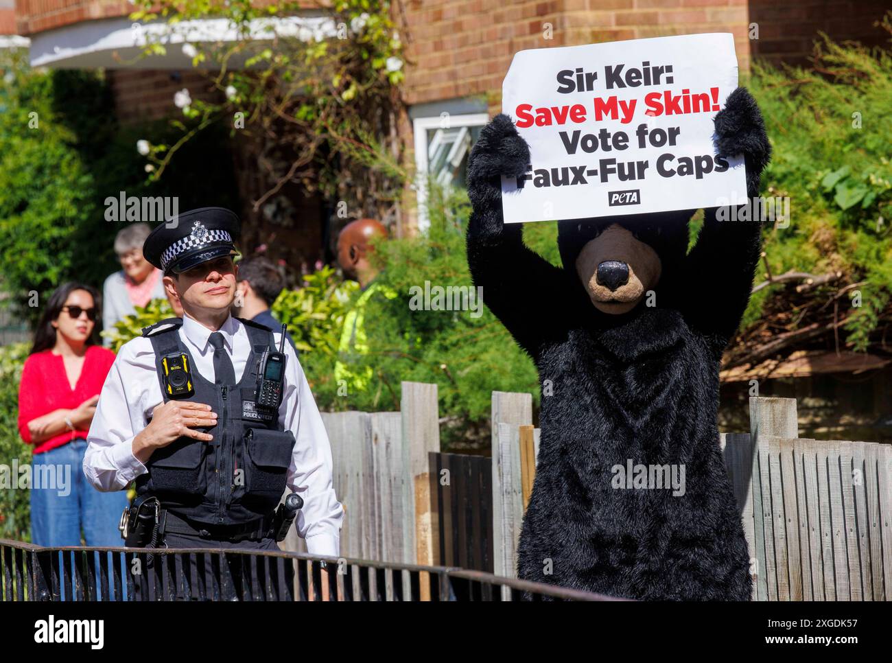 An anti-fur Peta protestor dressed as a bear outside the polling ...
