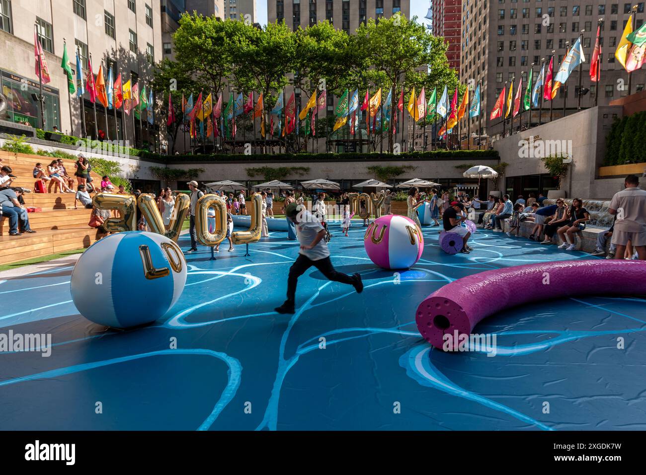 Visitors to Rockefeller Center participate in the interactive “Pool ...