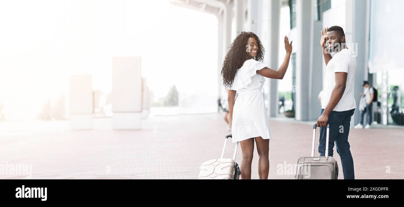 Smiling Couple Waving Goodbye at Airport Terminal Stock Photo - Alamy