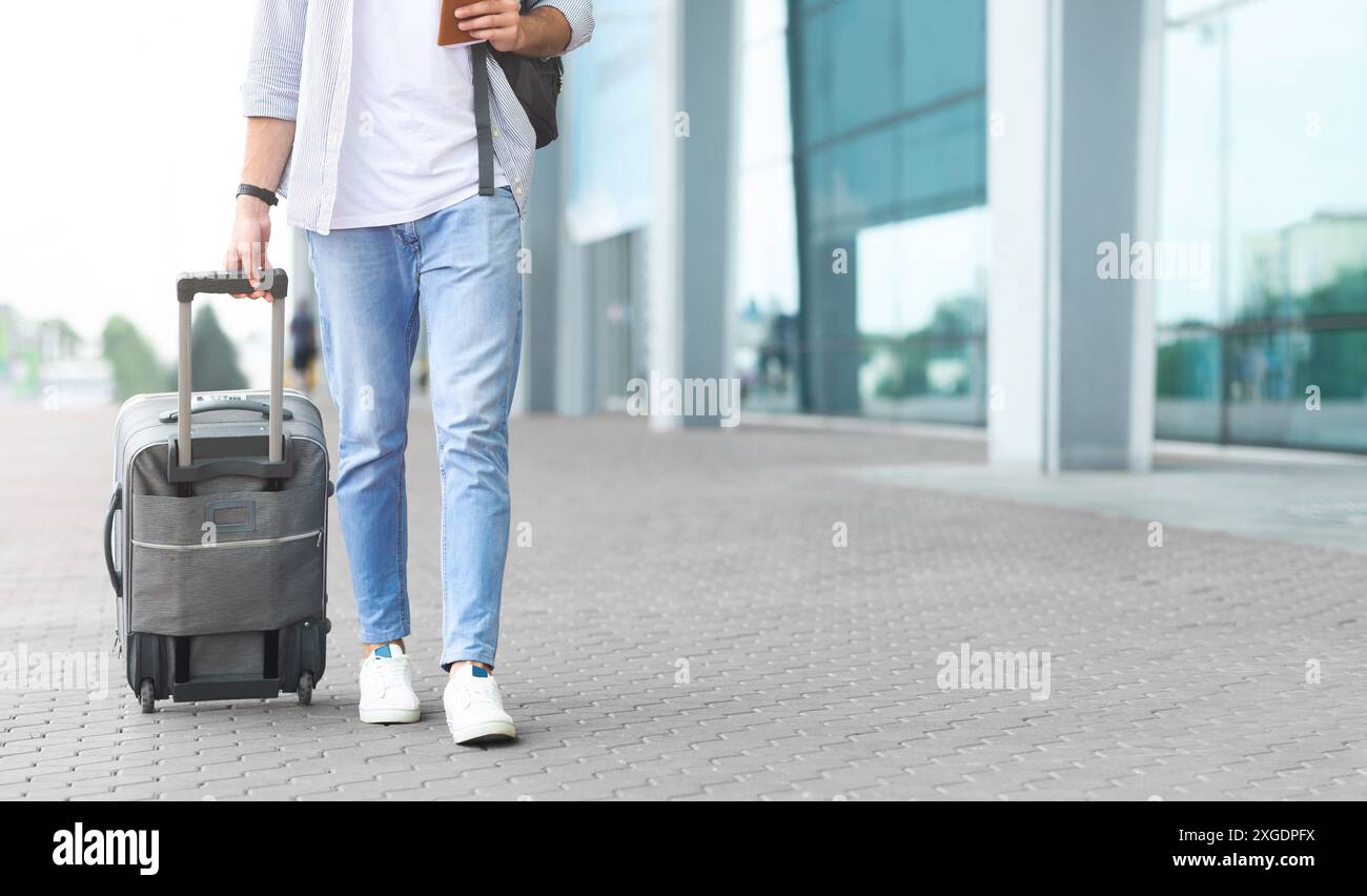 Man walking to airport with luggage, going on board Stock Photo - Alamy