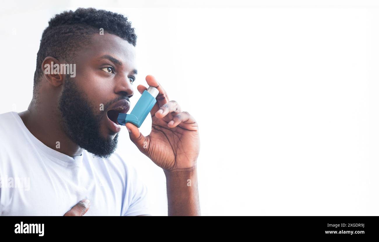 Man Using an Inhaler to Treat Asthma Stock Photo - Alamy
