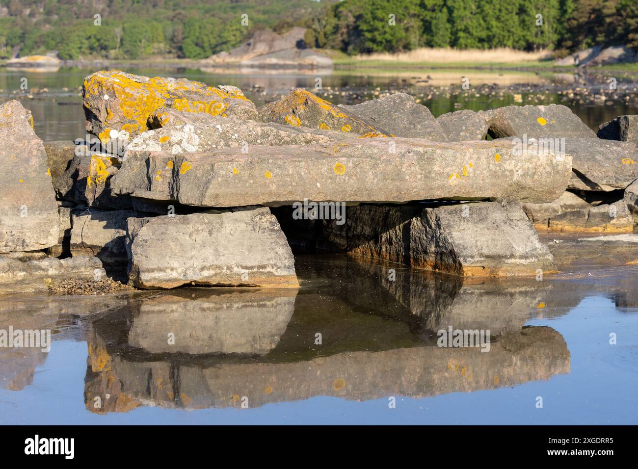 Stone barrier with small tunnel for tidal water control in farmland ...