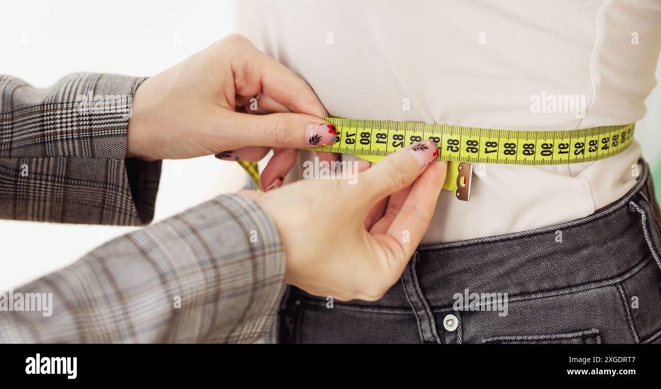 Female tailor measuring waist young hi-res stock photography and images ...