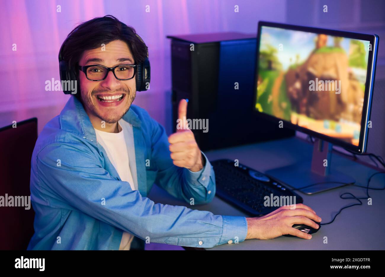 Happy Gamer Giving Thumbs Up While Playing Video Game Stock Photo - Alamy