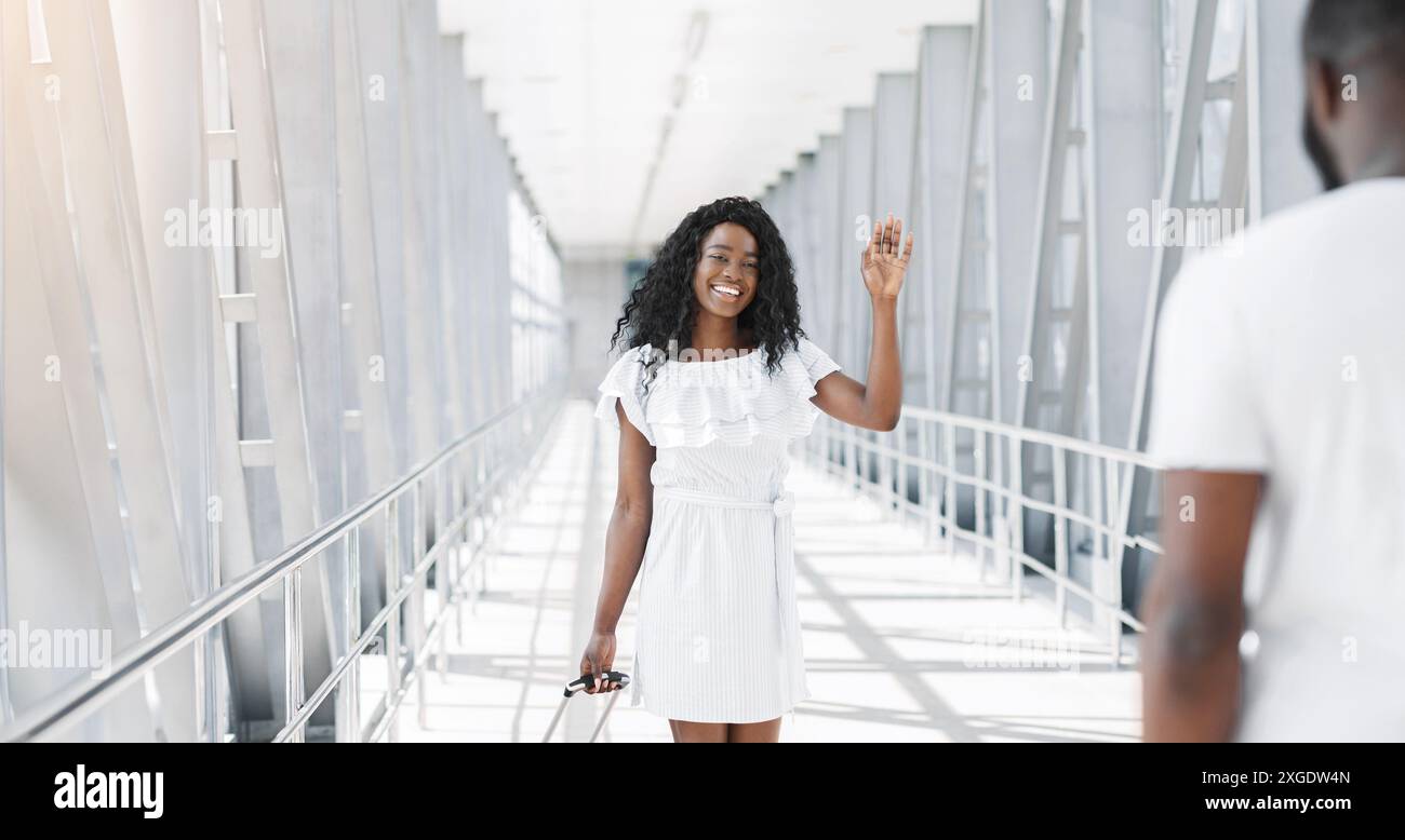 Woman Waving Goodbye at Modern Airport Terminal Stock Photo - Alamy