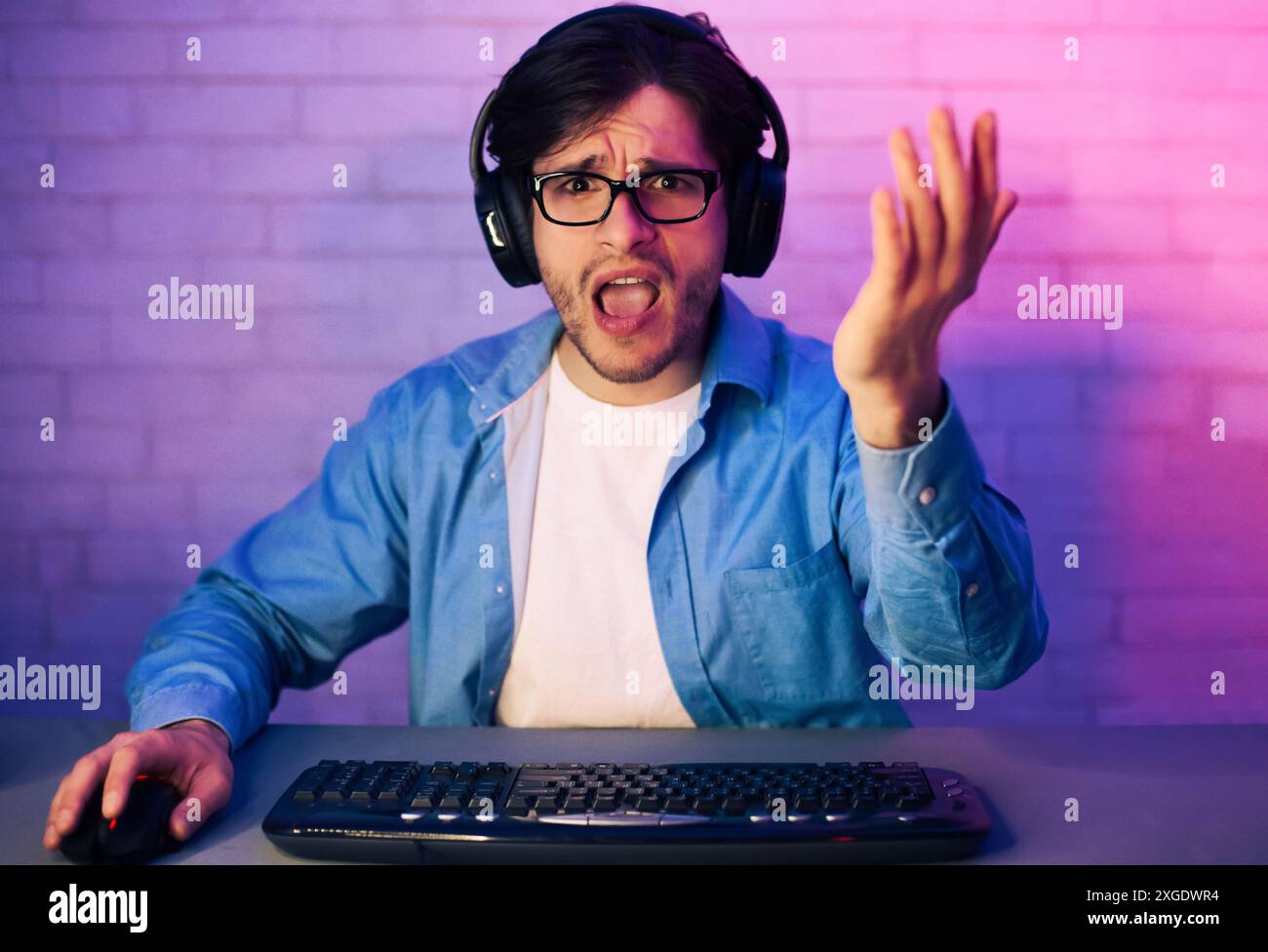 Frustrated Gamer Wearing Headphones at His Computer Stock Photo - Alamy