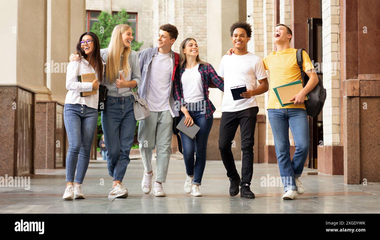 Multiracial students walking after classes in university campus Stock ...