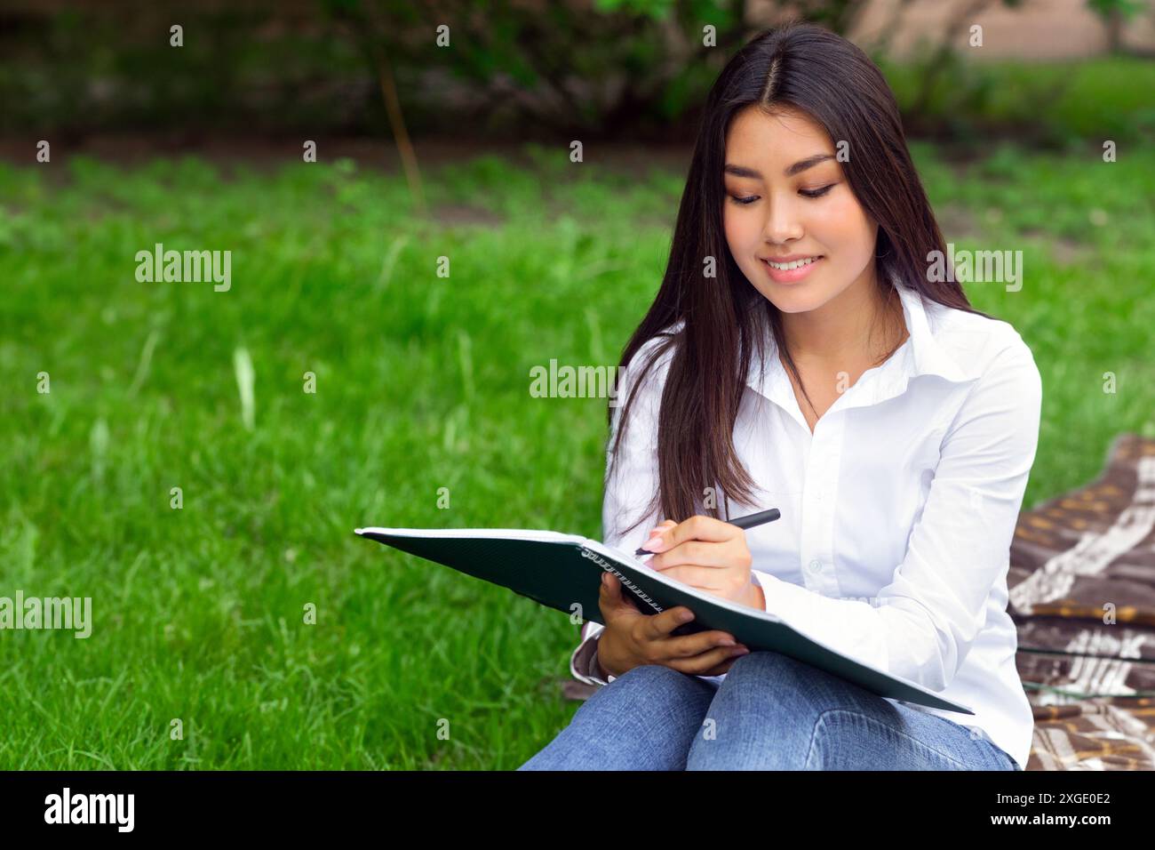 Asian student girl studying, taking notes in campus Stock Photo - Alamy
