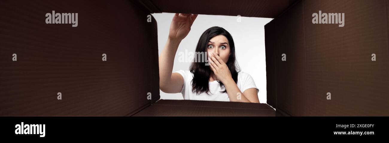 Shocked Lady Looking Inside Cardboard Moving Box Stock Photo - Alamy