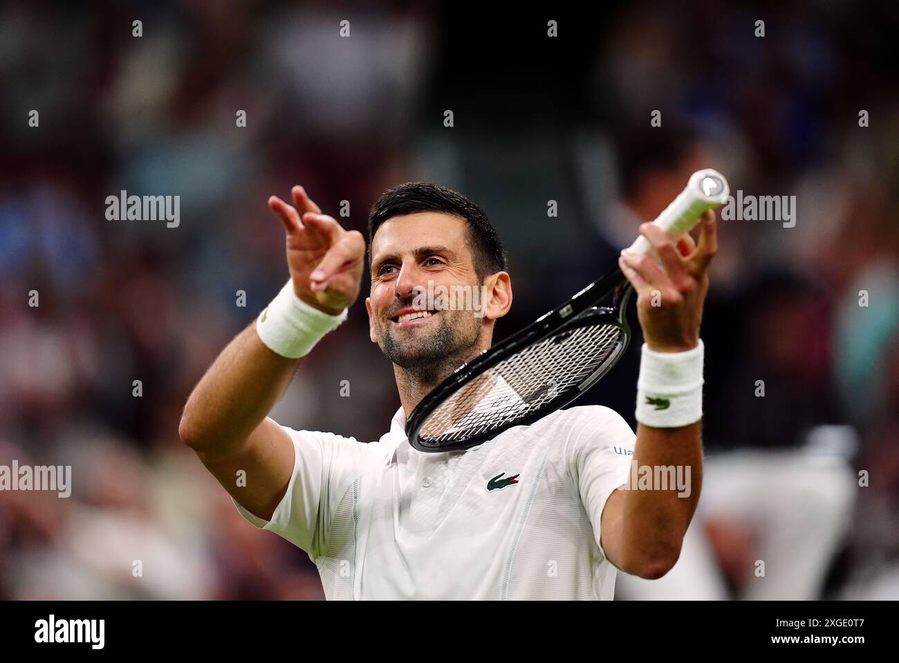Novak Djokovic pretends to play a violin after beating Holger Rune on day eight of the 2024 ...