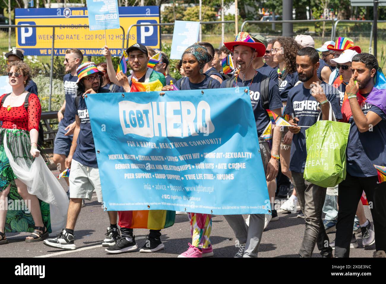 People marching and holding up a banner for LGBT HERO - a national ...