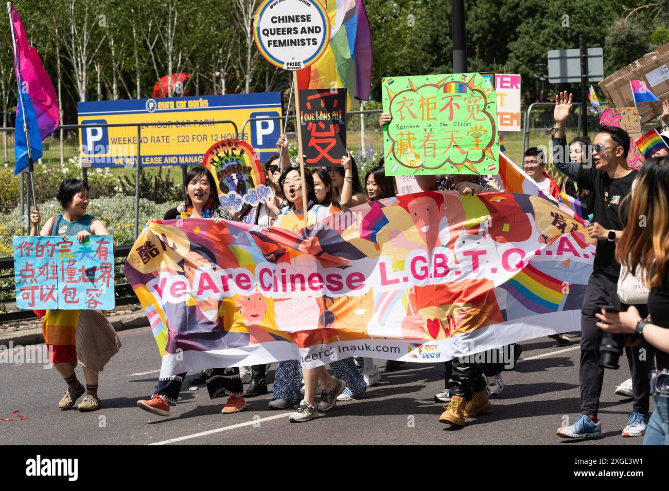 A group of Chinese people marching at London Pride 2024 carrying a ...