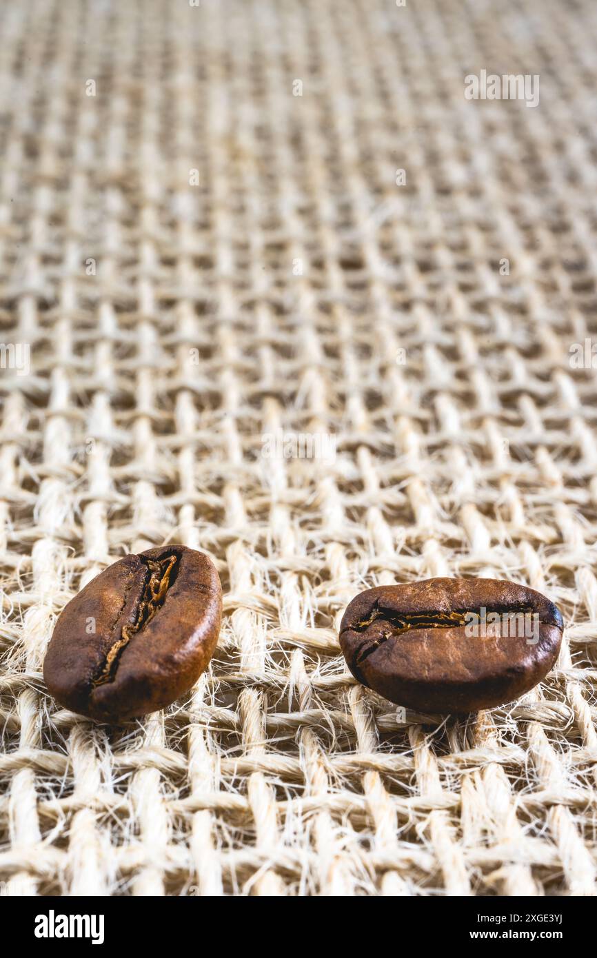 Close up from a few coffee beans laying down on a Burlap fabric ...
