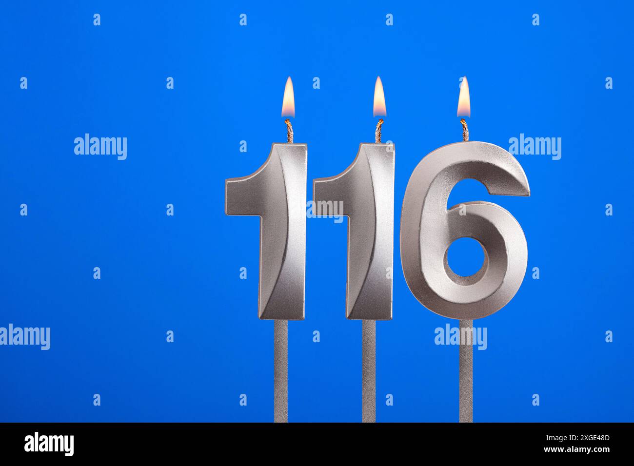 Birthday number 116 - Candle lit on blue background Stock Photo - Alamy