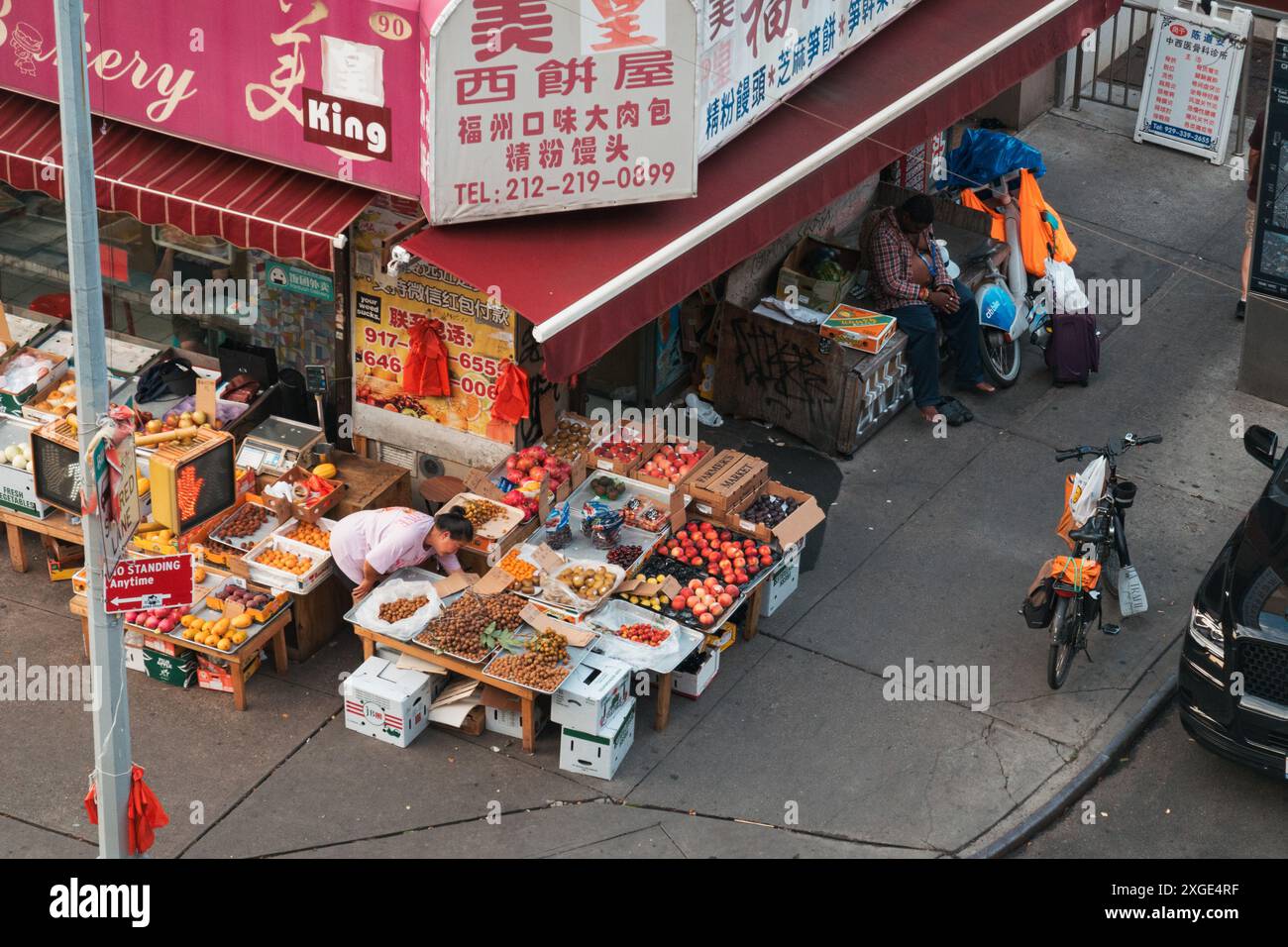 a grocer displays their fruit and vegetables on the street in Chinatown ...