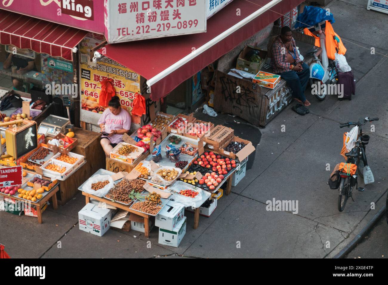 a grocer displays their fruit and vegetables on the street in Chinatown ...