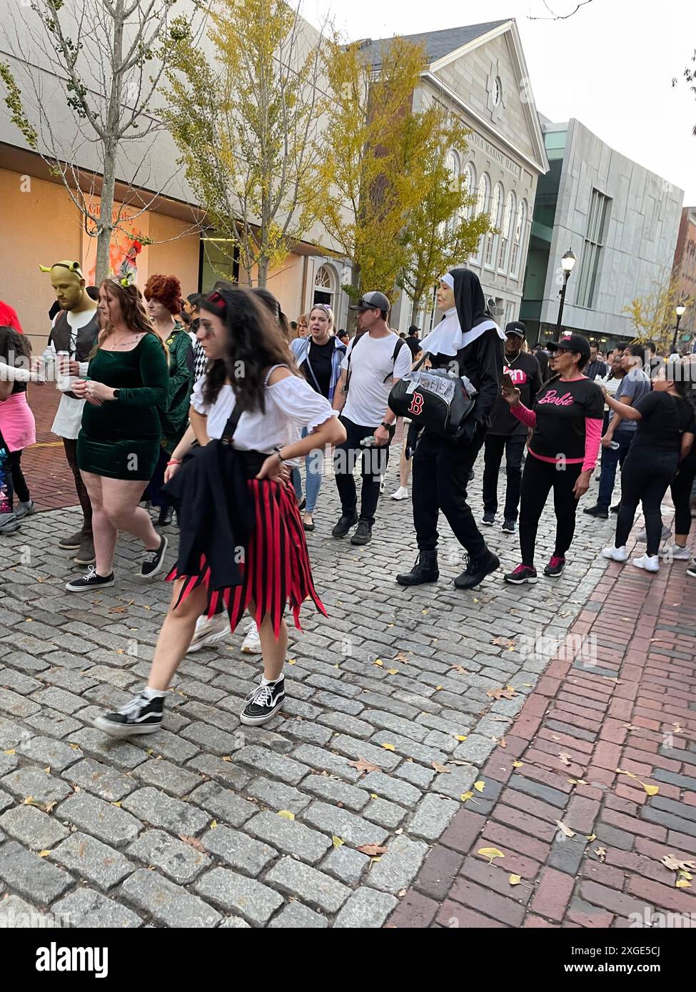 People n Halloween costume walk down the city streets of Salem ...
