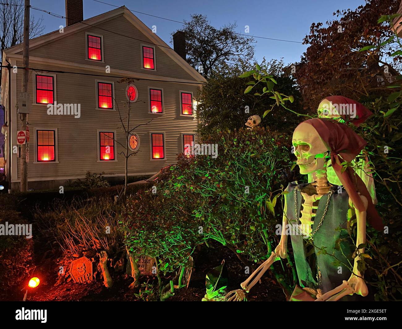 A skeleton in pirates clothes sits illuminated in the front yard while ...