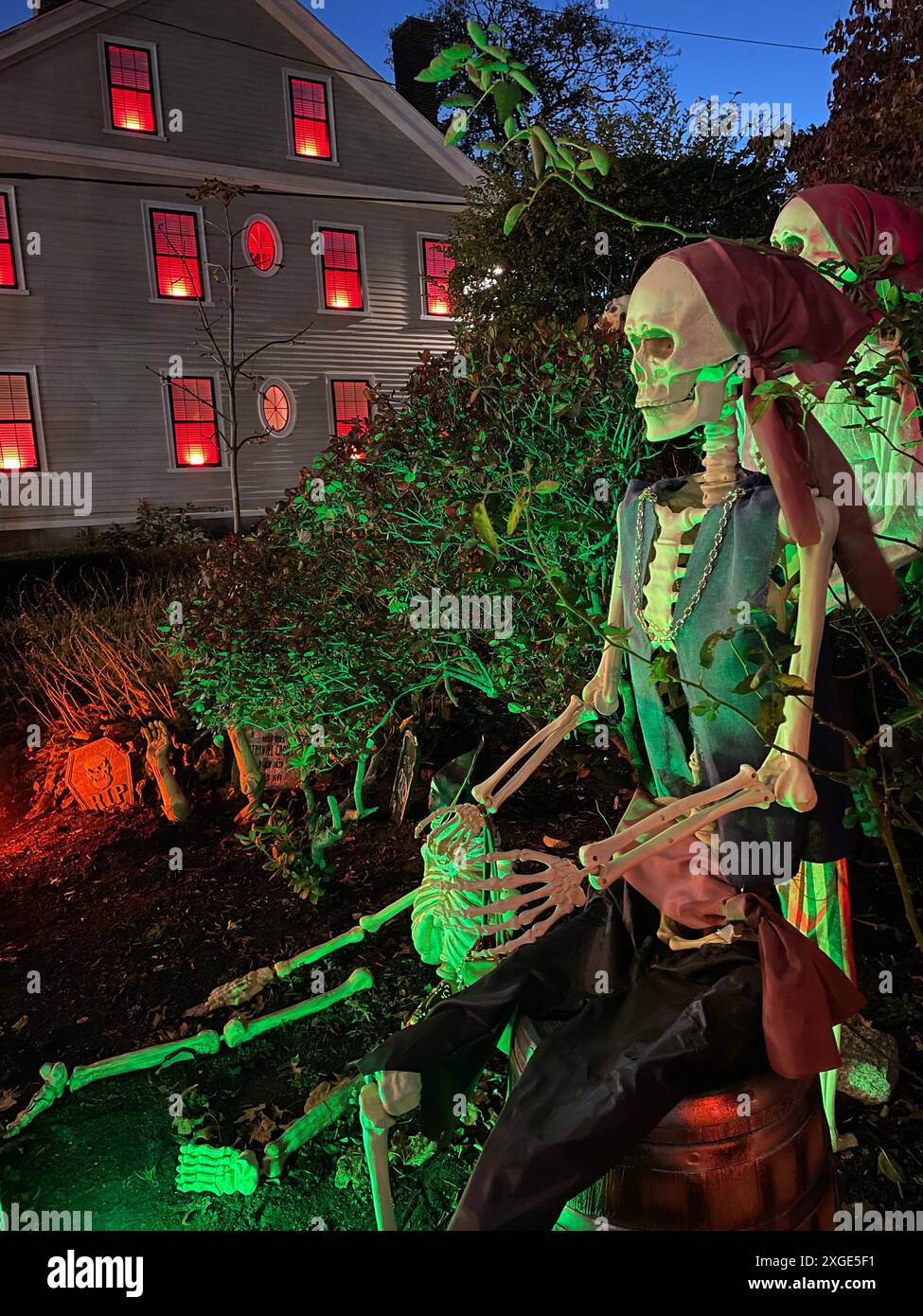 A skeleton in pirates clothes sits illuminated in the front yard while ...