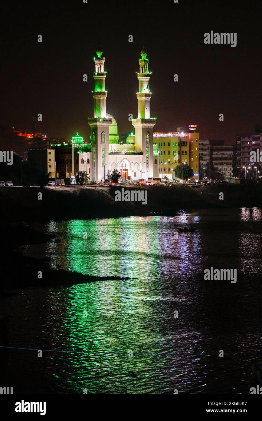 The Green Mosque near Luxor, Egypt, glows in the night along the Nile ...