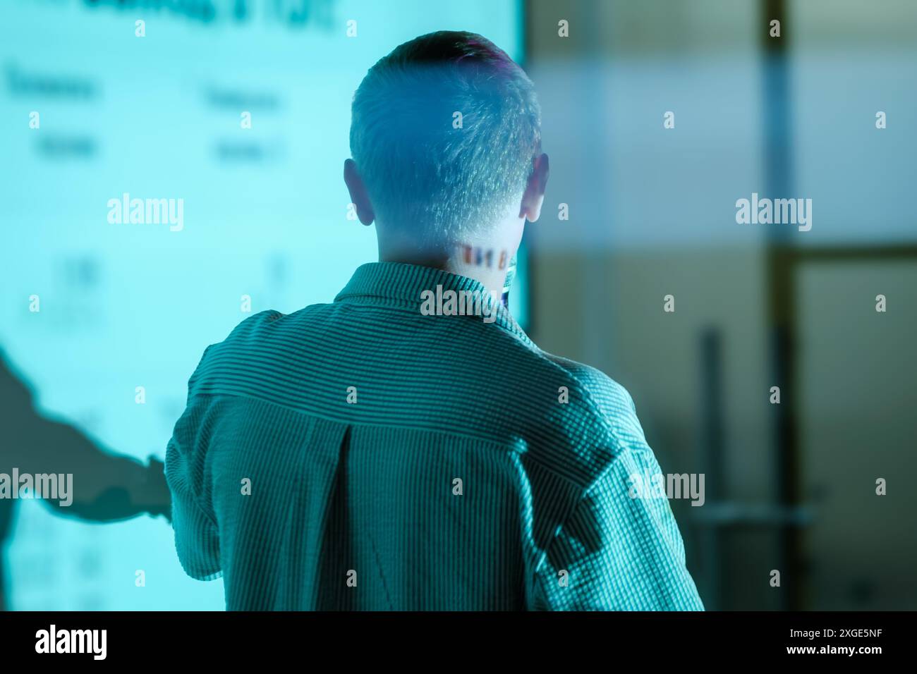 Person giving a presentation in an office setting with data projected ...