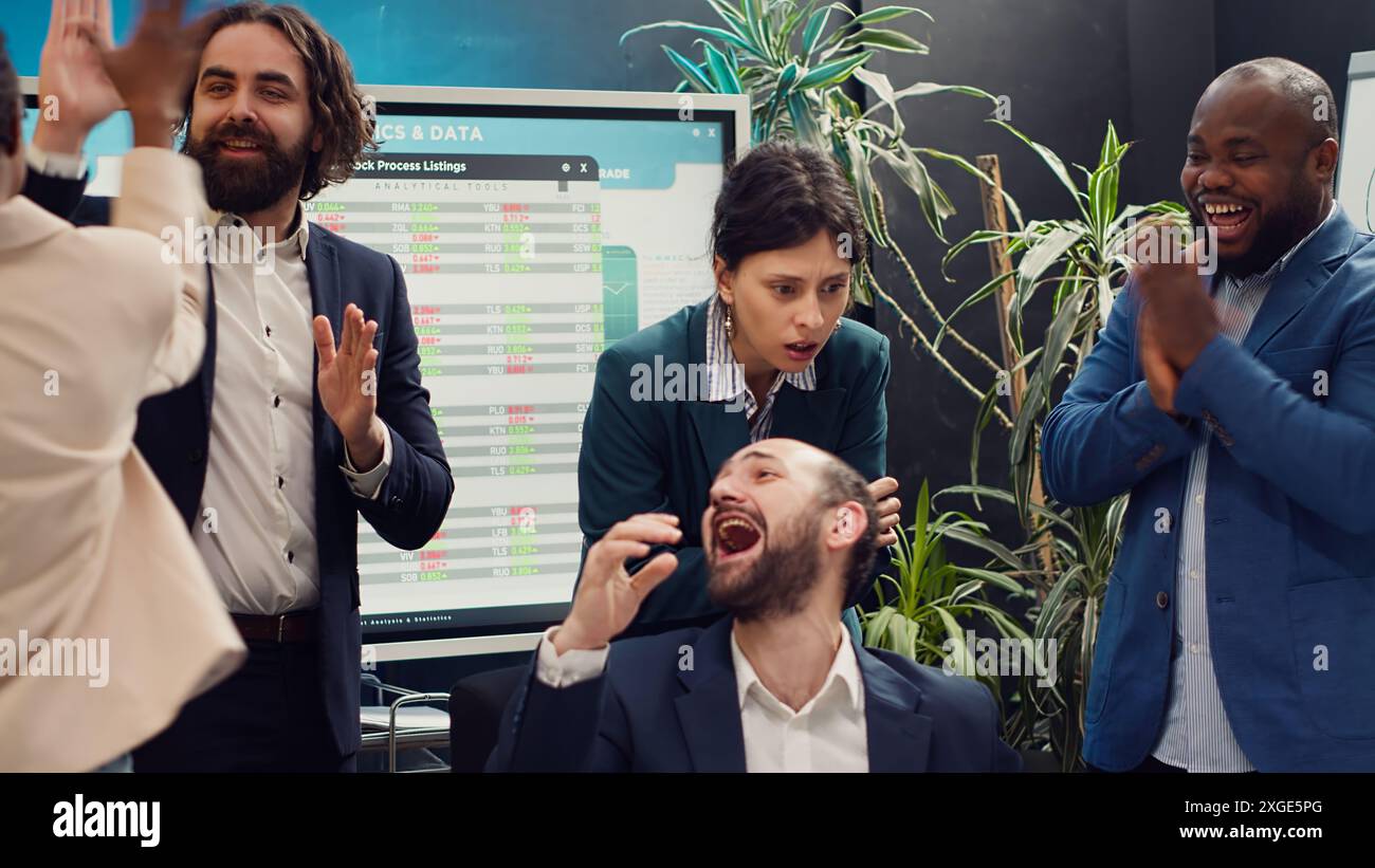 Joyful proud employees celebrating their business success finding out ...