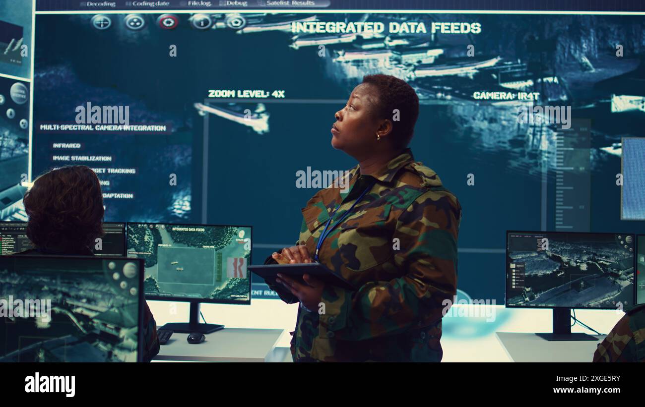 Woman high tech specialist studying satellite CCTV visualization on a ...