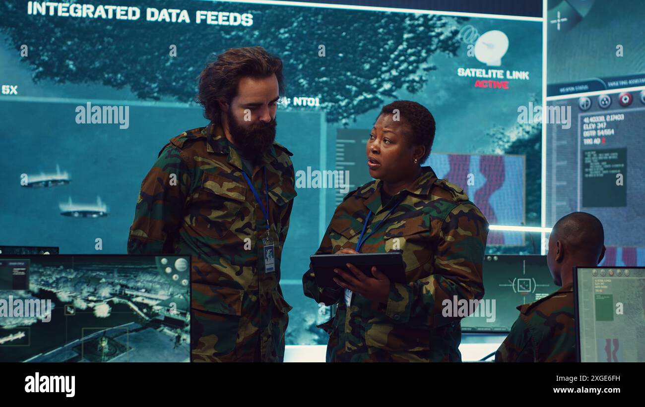 Diverse team of army officers reviewing important information from the ...