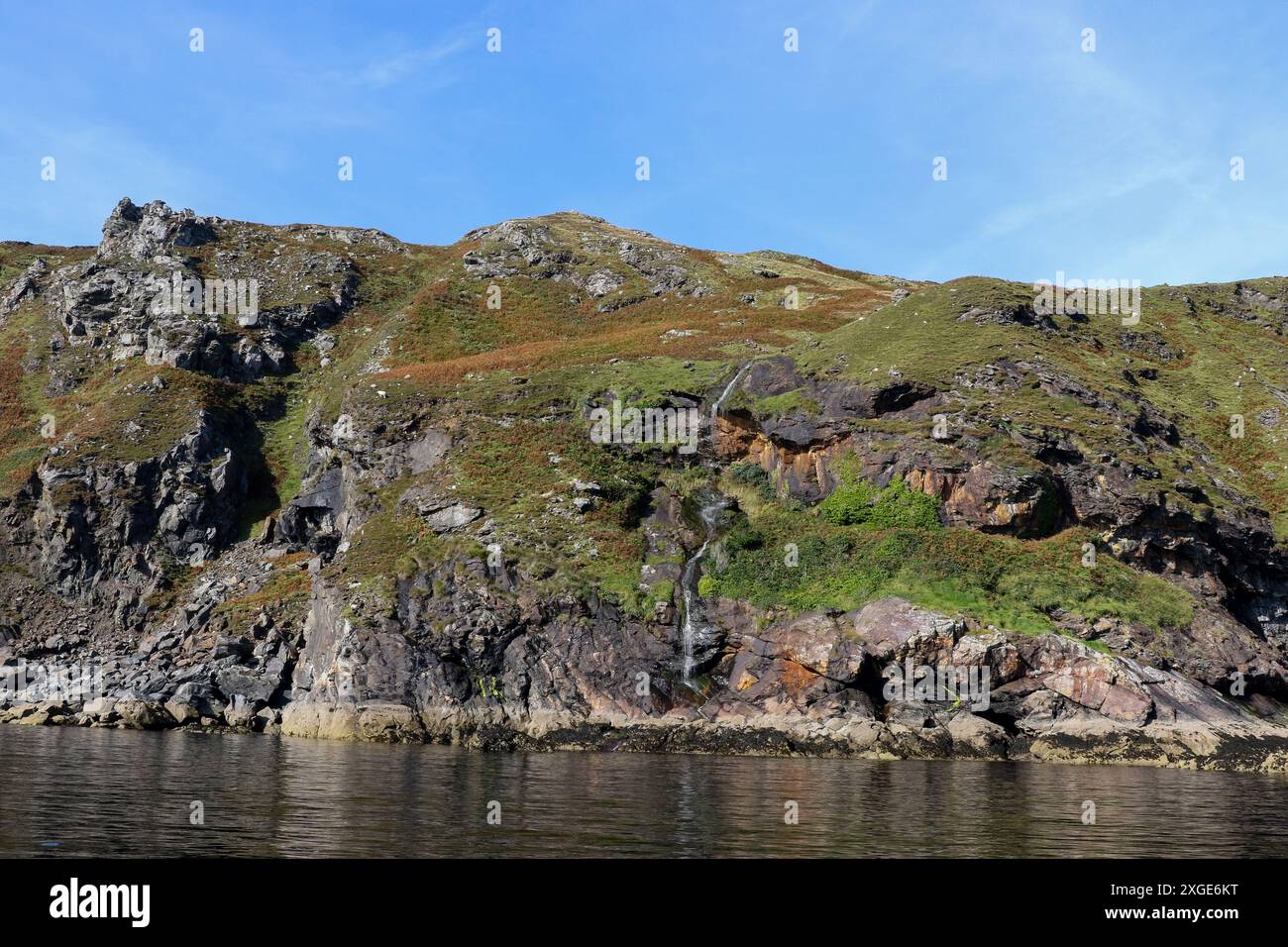 Freshwater waterfall into sea Irish coastal headland and cliff near ...