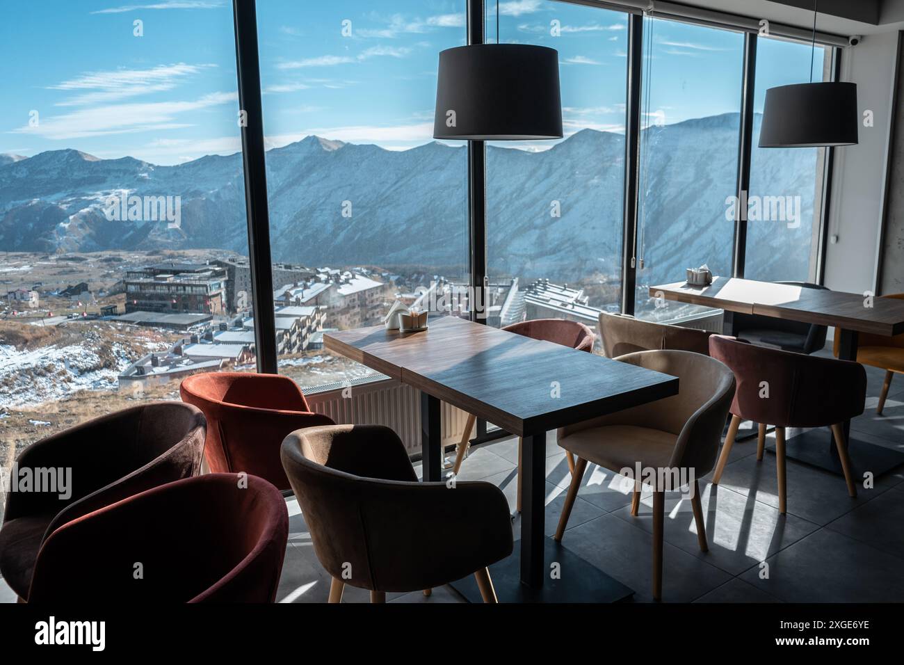 modern restaurant with panoramic windows and snowy mountains with ...