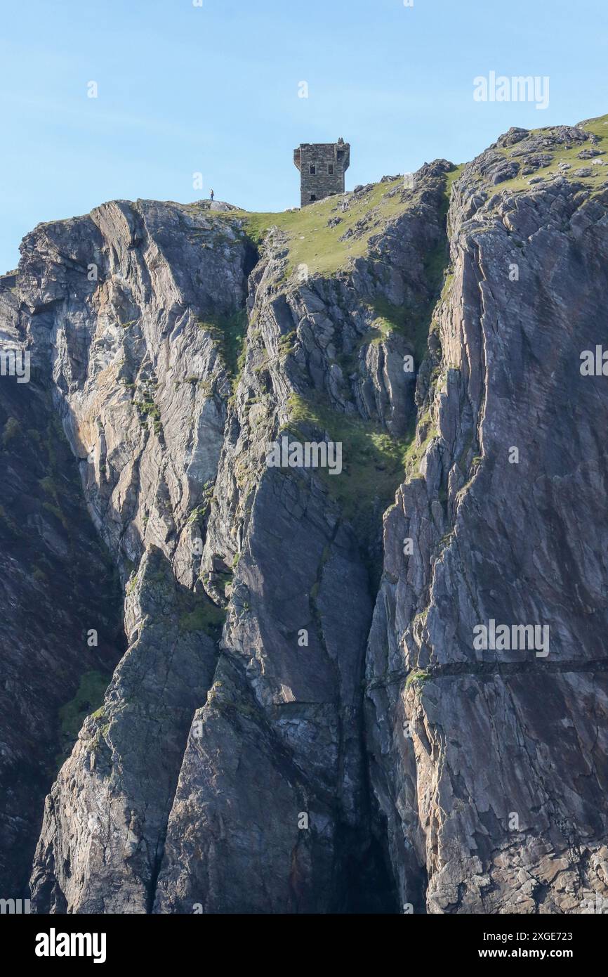 Irish sea cliff Napoleonic tower with man on coastal headland Carrigan ...